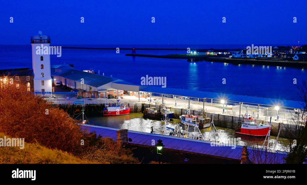 North Shields fish quay and the Low Lights lighthouse at night with ...