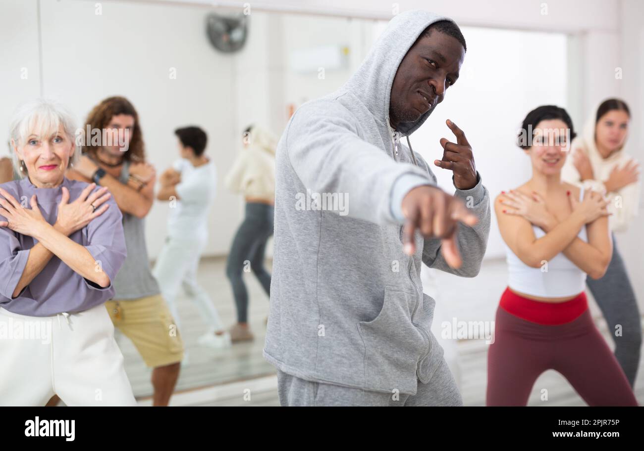 Group of multinational people practicing new modern dance techniques ...