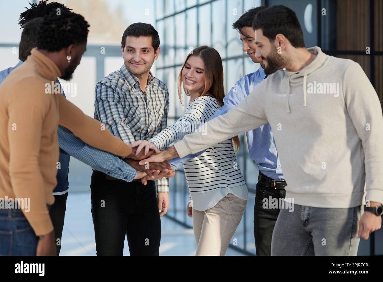 Happy colleagues welcome businessman to their successful team Stock ...