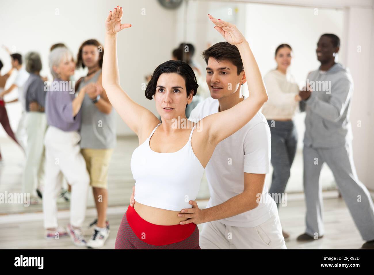 Adult couple of dancers learns partner dance Stock Photo - Alamy
