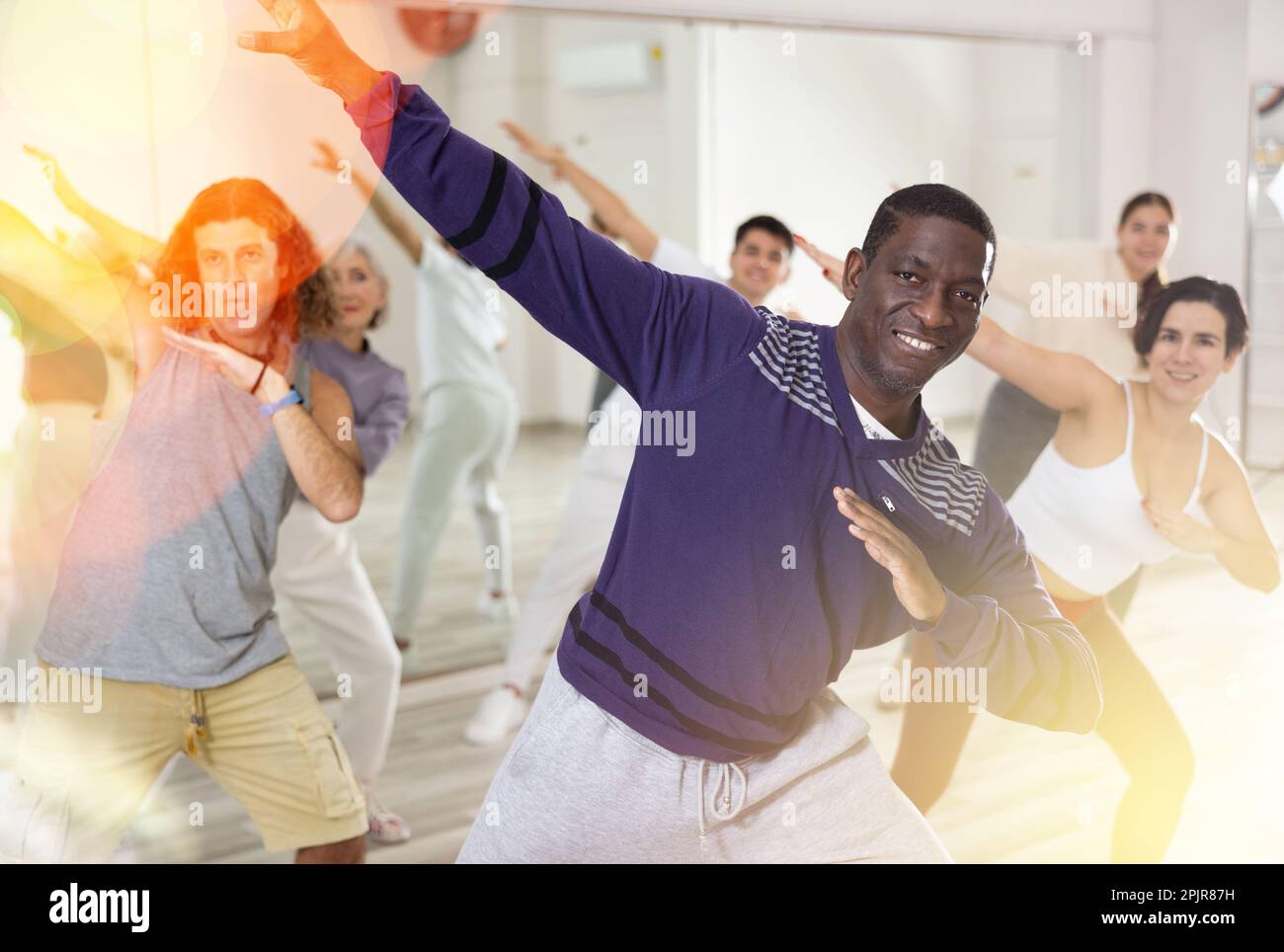 Happy african man learning new modern dance in group dance lesson Stock ...