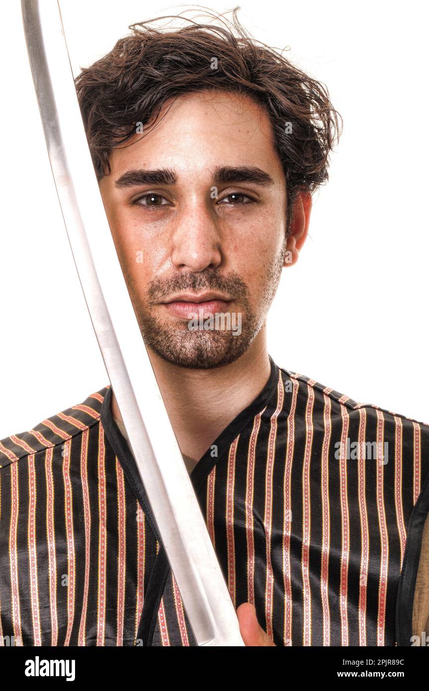 Young fierce looking man with a sword Stock Photo - Alamy