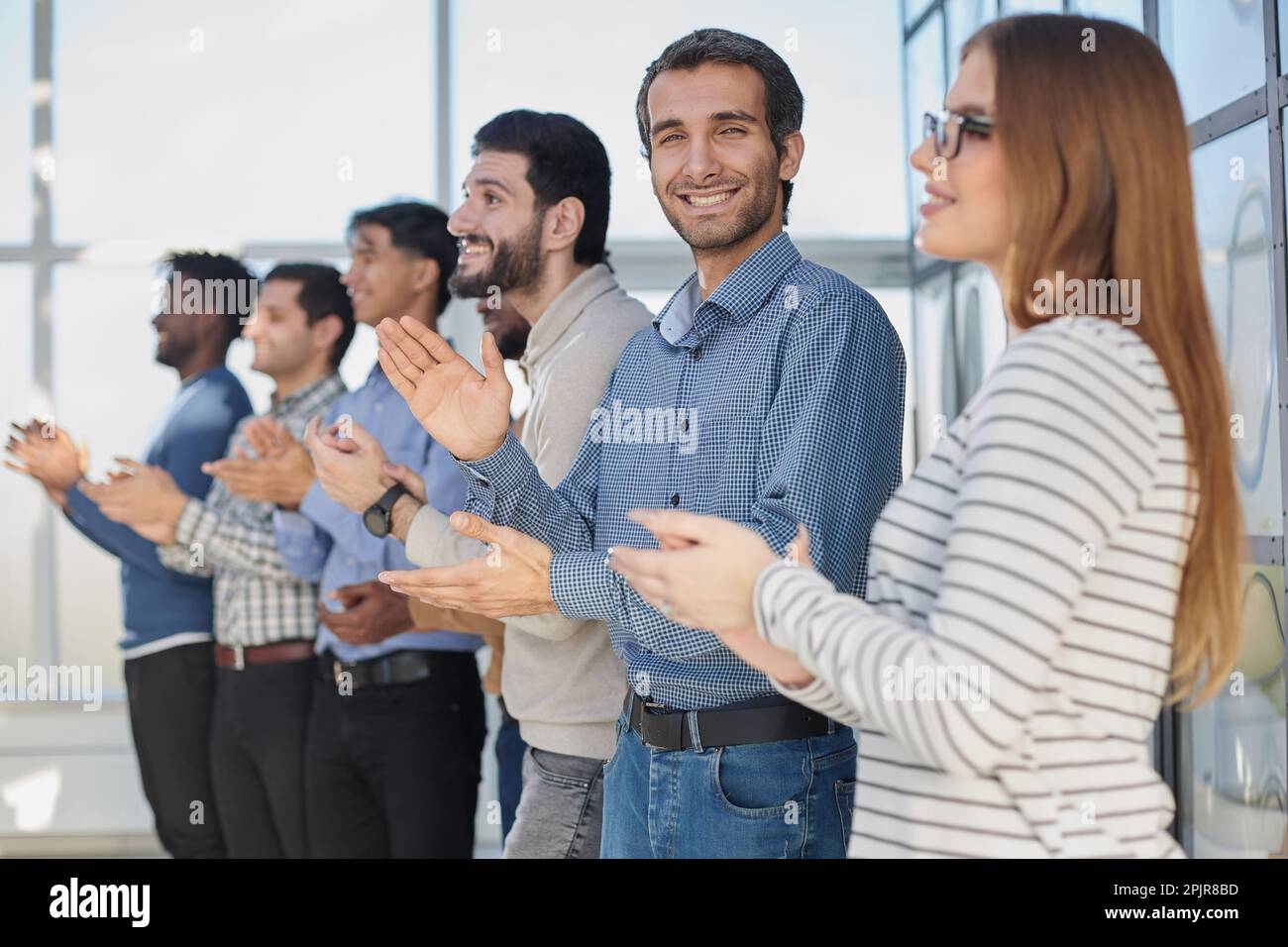 Happy business team applauding after successful meeting Stock Photo - Alamy