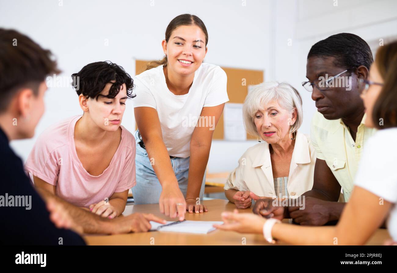 Teacher, together with group of adult students, are looking for ...