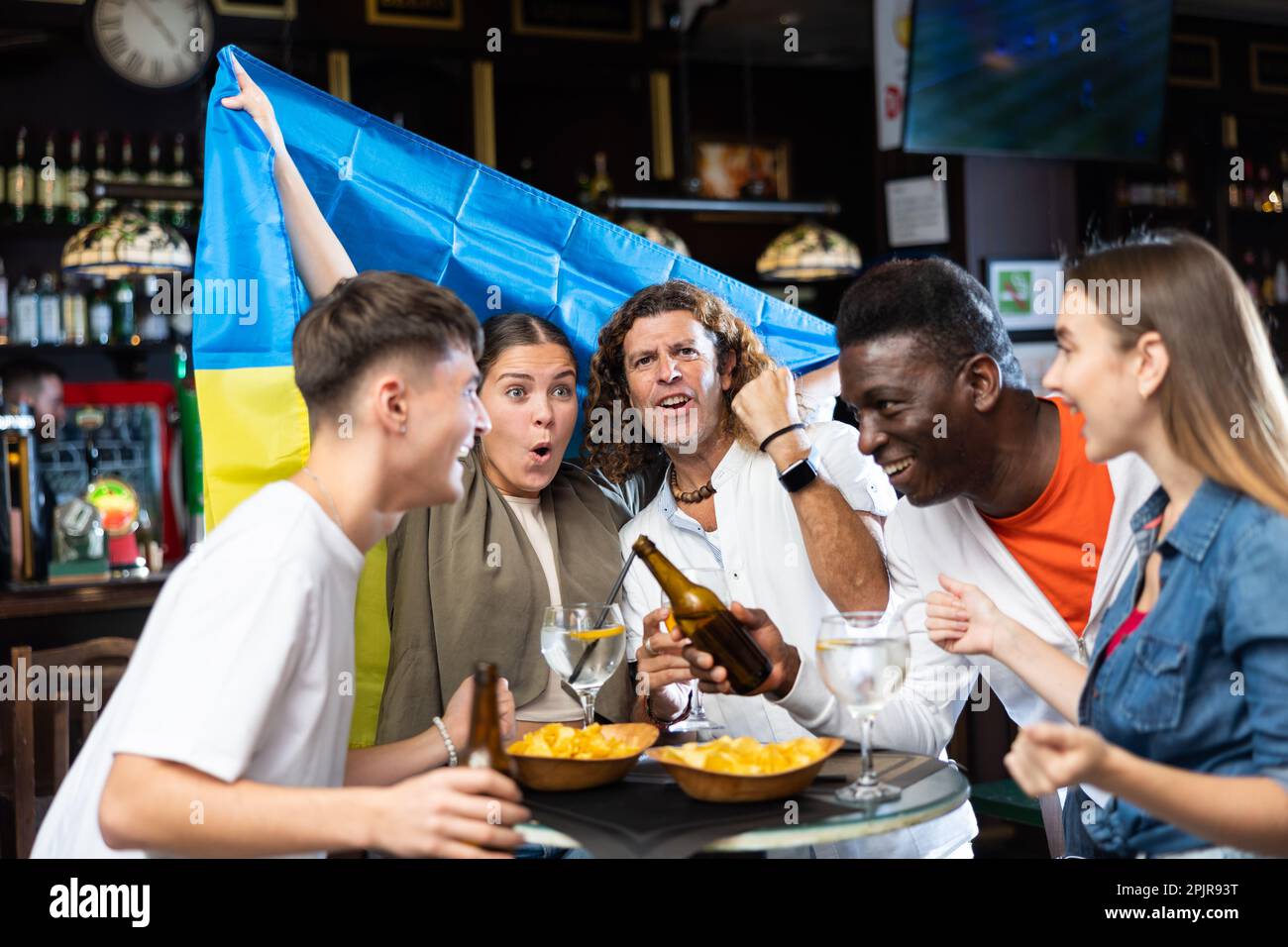 Happy friends of different ages drinking beer and celebrating the ...