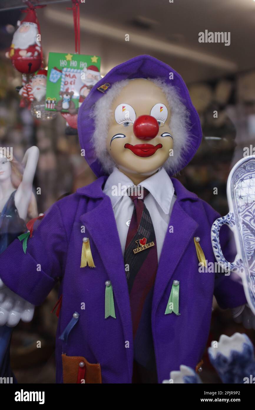 A Marionette clown puppet looking out of a shop window in Madeira ...
