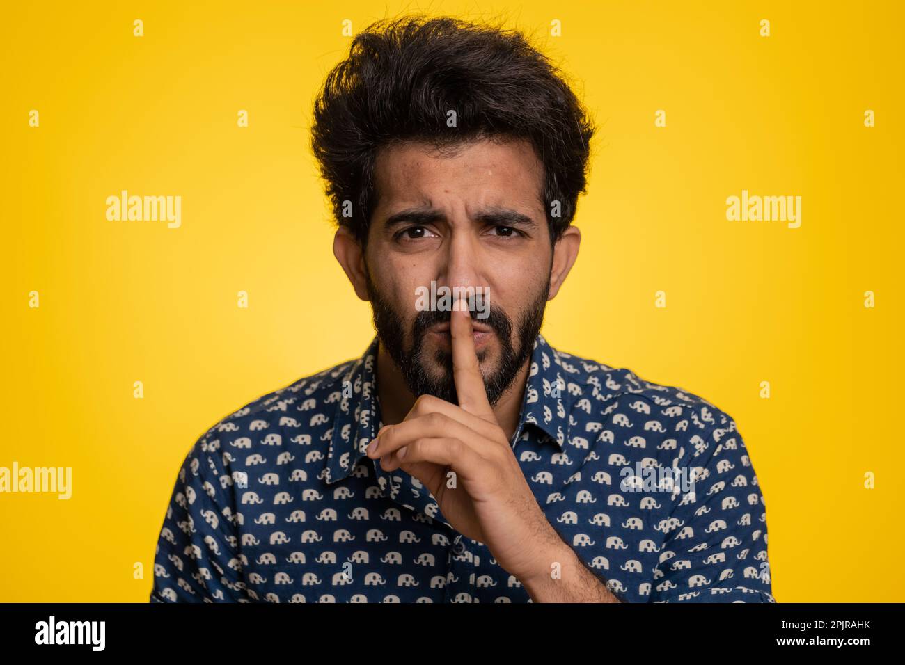 Shh be quiet please. Young indian man presses index finger to lips ...
