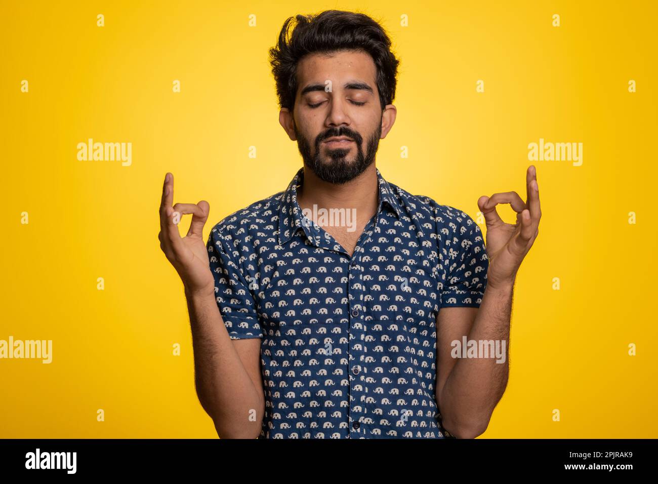 Keep calm down, relax, inner balance. Young indian man breathes deeply ...