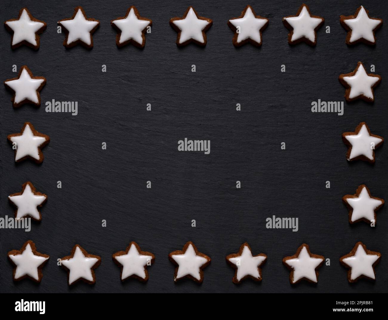 black slate board with Zimtstern star-shaped cinnamon cookie border and ...