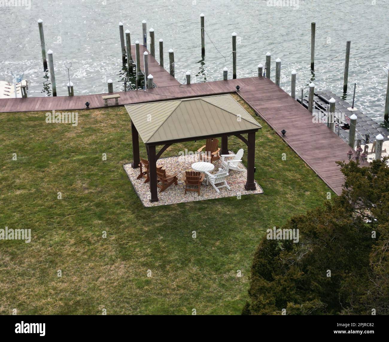 Drone view from above of a gazebo in a backyard on the water with ...