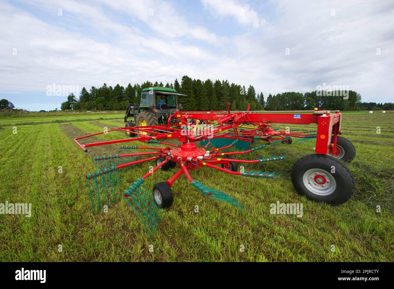 Silage harvesting, John Deere tractor with double tedder, turning cut ...