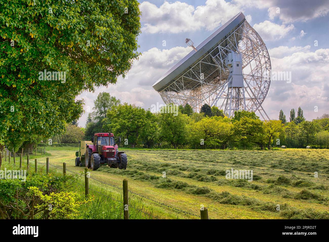 Radio telescope with tractor and baler with silage in foreground ...