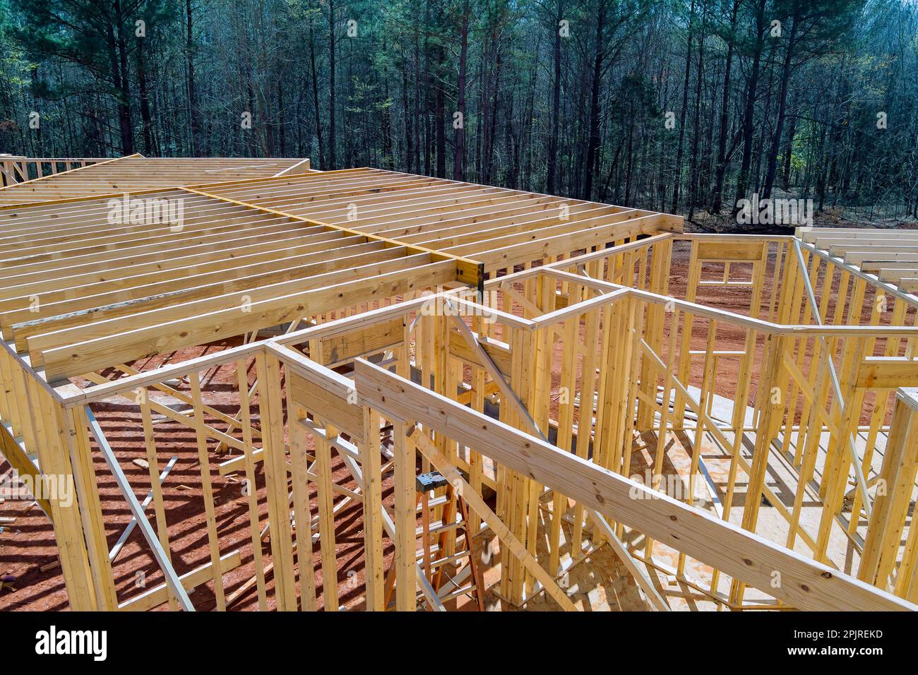 Building wooden house begins with framing beams which support layout of ...