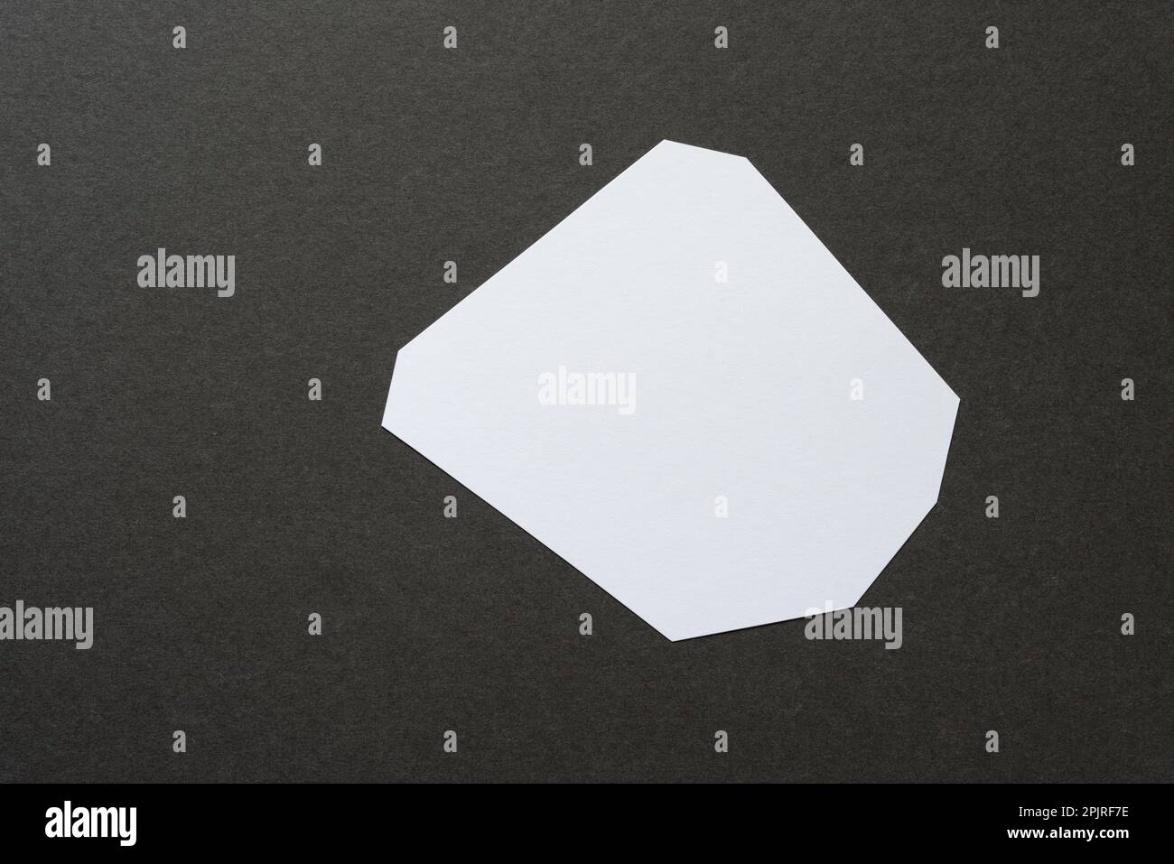 polygon paper shape on grey cardboard Stock Photo - Alamy