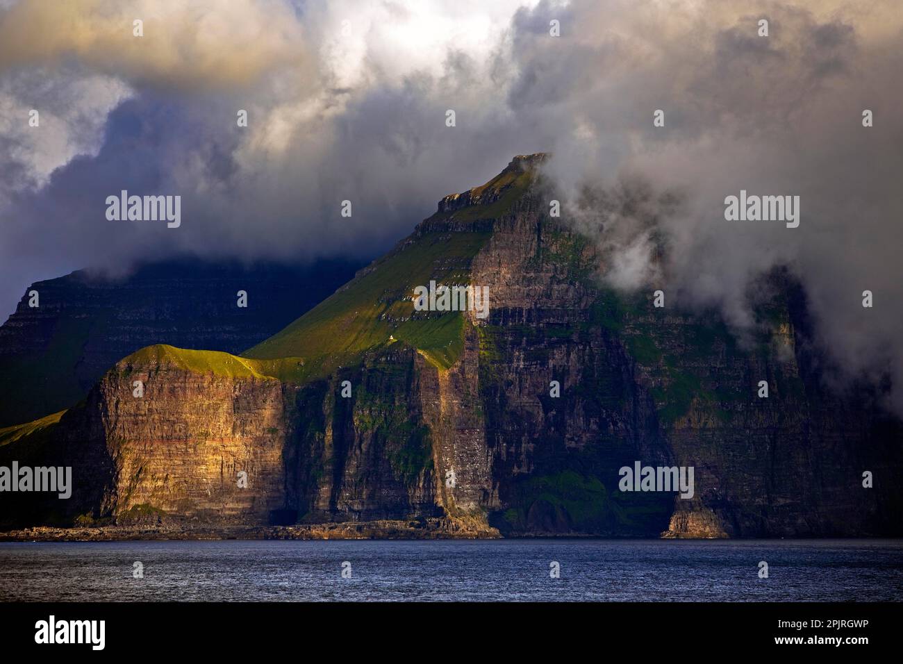 The Faroe Island of Kalsoy in the Atlantic Ocean with Sun and Clouds ...