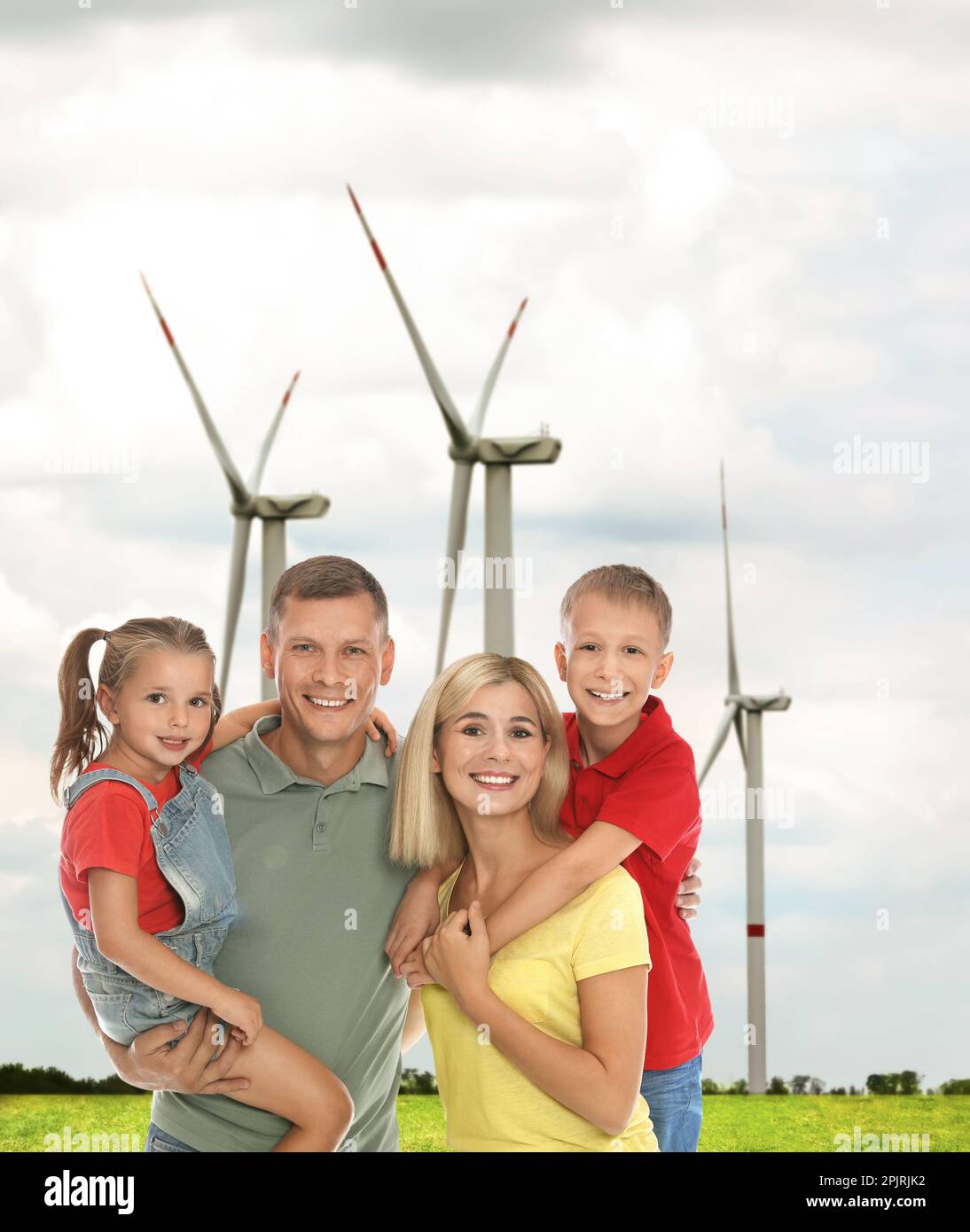 Happy family with children and view of wind energy turbines Stock Photo ...