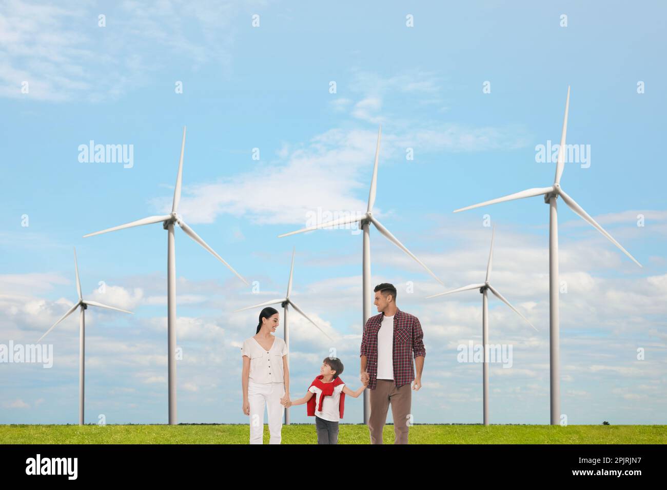 Happy family with child and view of wind energy turbines Stock Photo ...