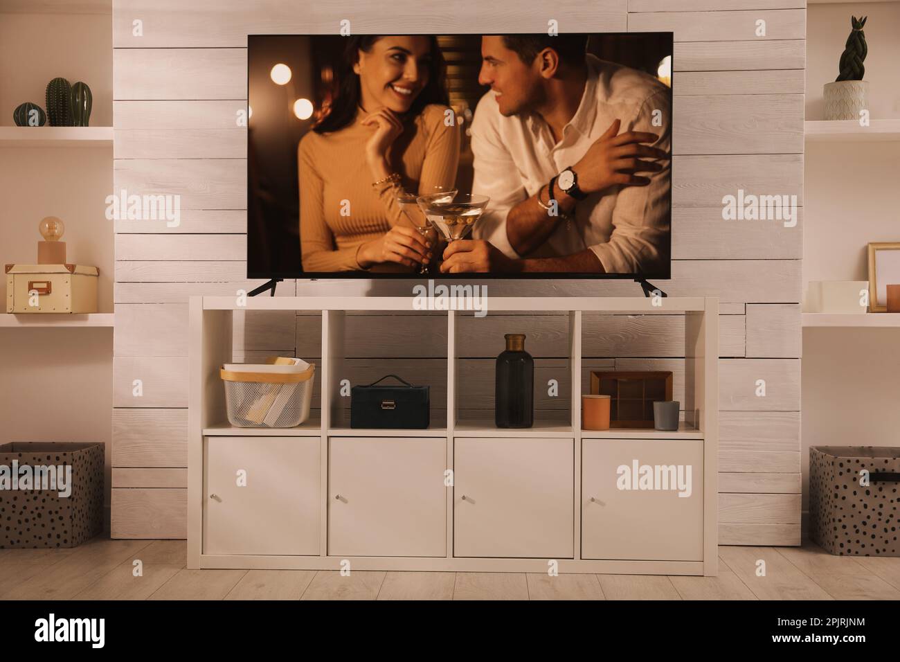 Scene of romantic movie on TV in room Stock Photo - Alamy