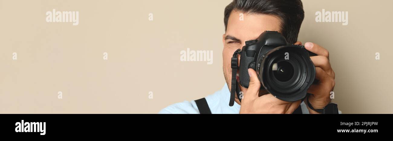 Professional photographer with camera beige background, space for text ...