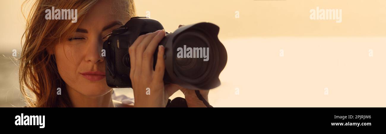 Photographer taking photo with professional camera outdoors, space for ...