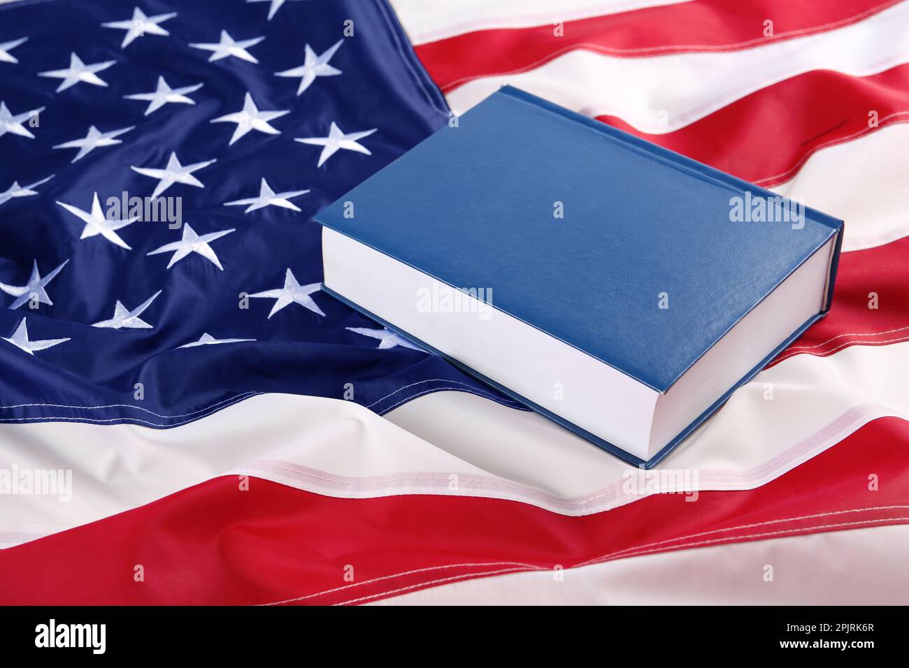 Blue hardcover book on national American flag Stock Photo - Alamy