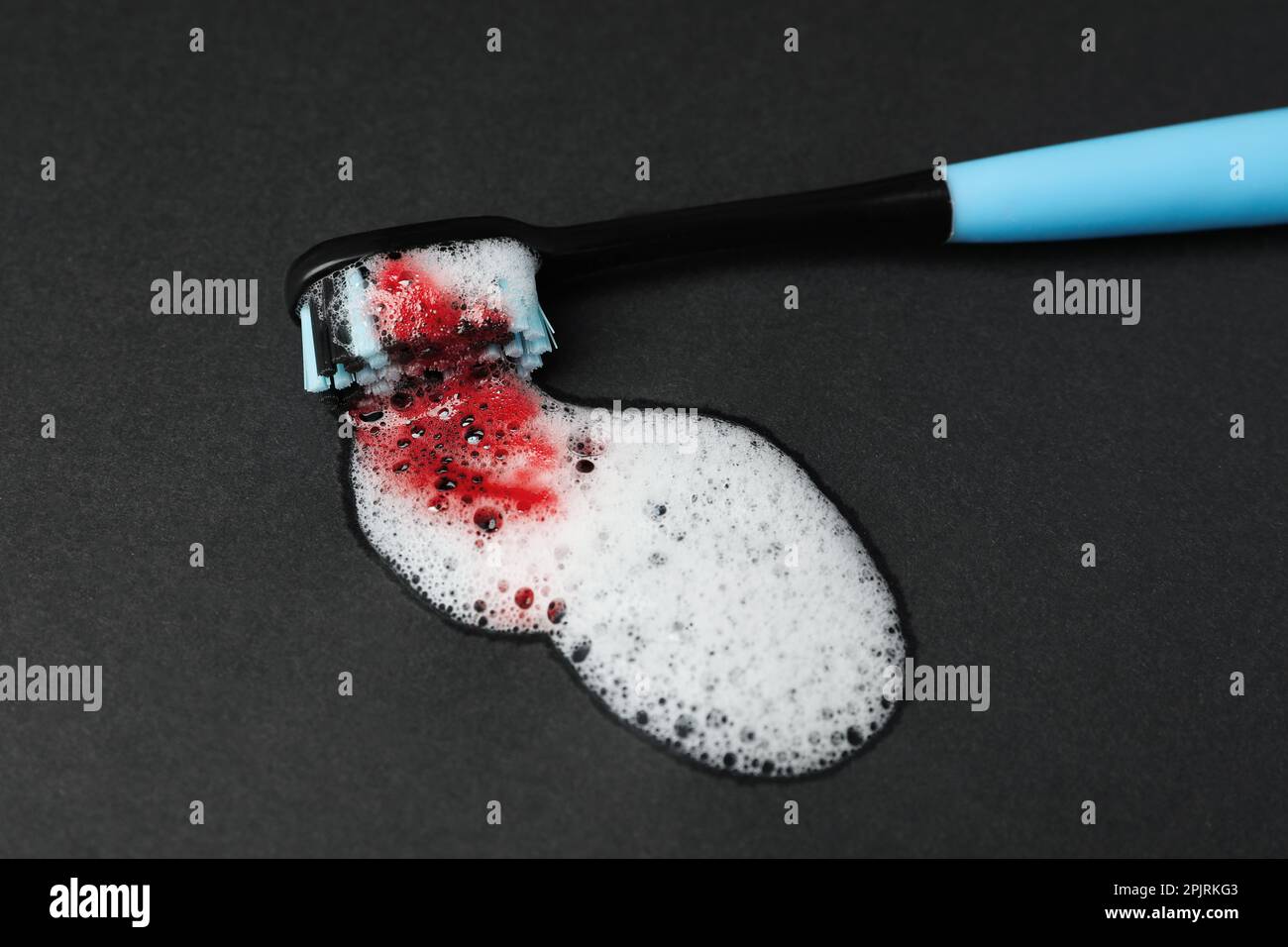 Toothbrush with paste and blood on black background, closeup. Gum ...