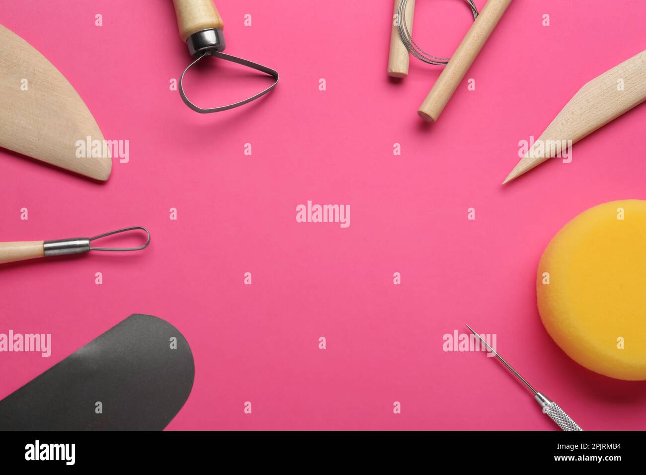 Set of clay modeling tools on pink background, flat lay. Space for text ...
