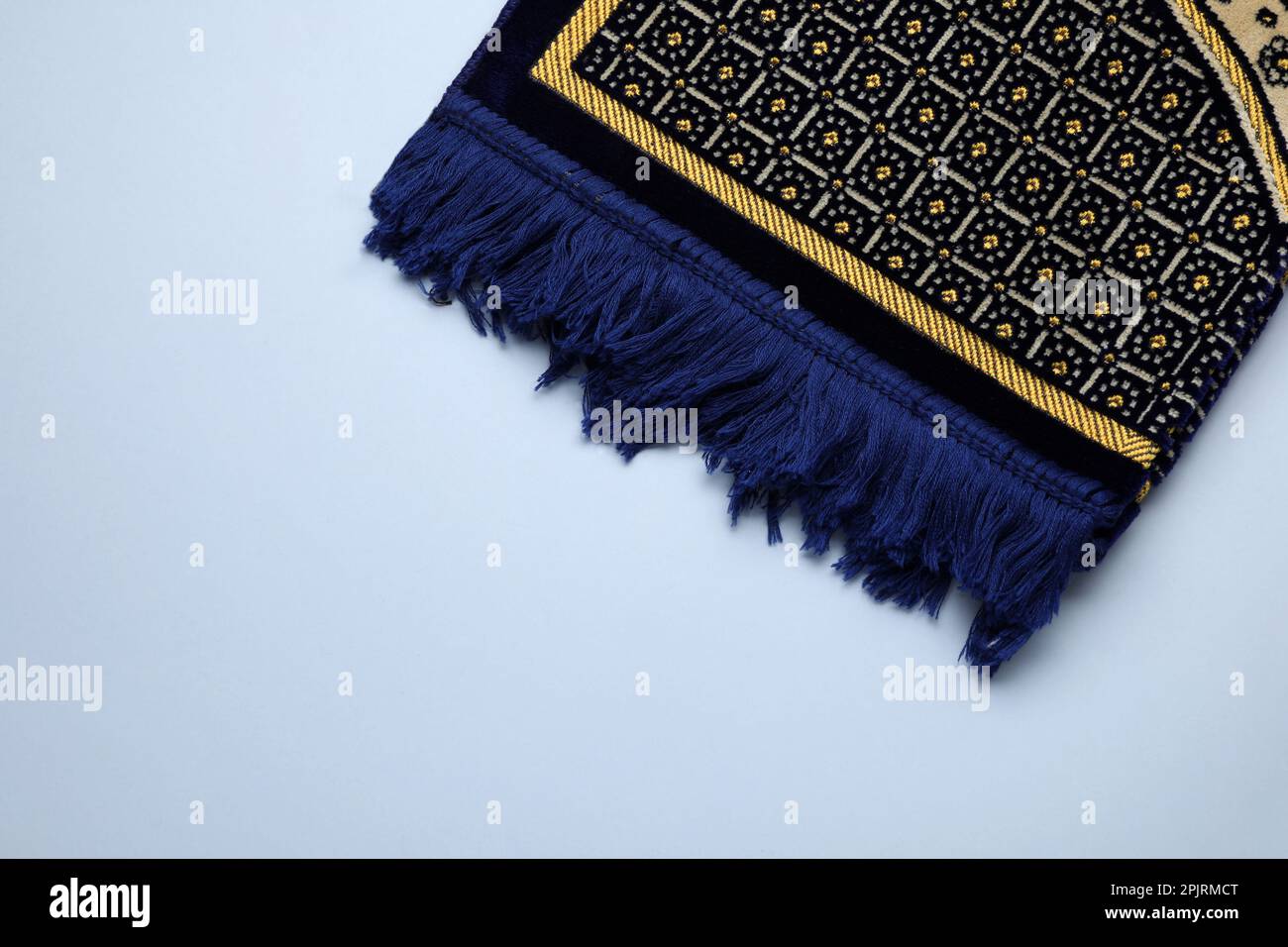Muslim prayer rug on light background, top view. Space for text Stock ...