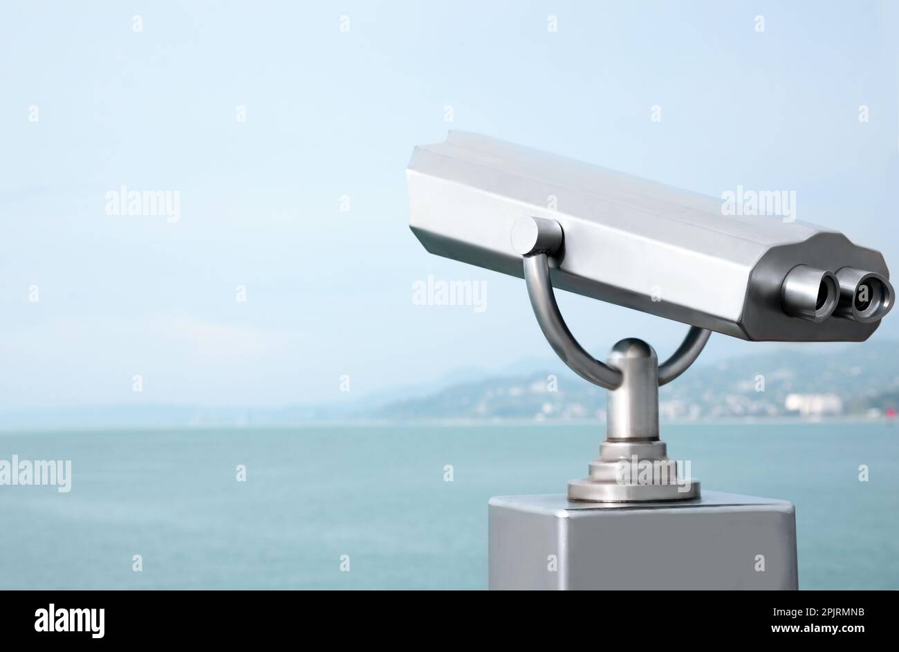 Metal tower viewer installed near sea, space for text. Mounted ...