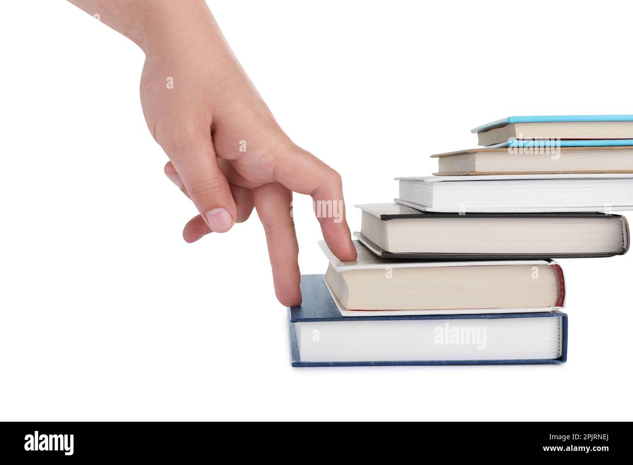 Woman imitating stepping up on books with her fingers against white ...