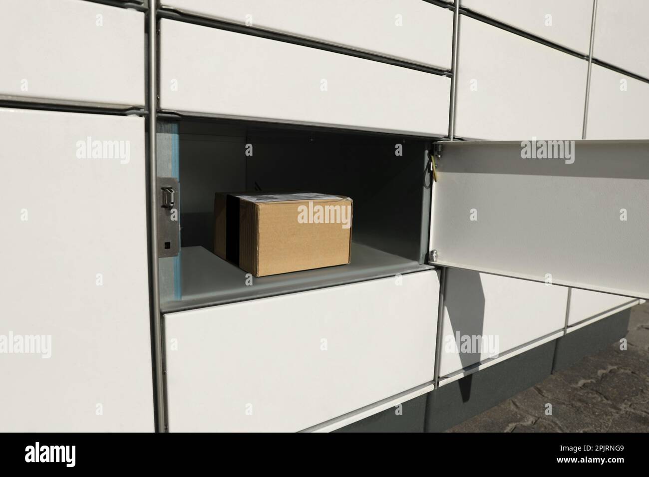 Open box with package in parcel locker Stock Photo - Alamy