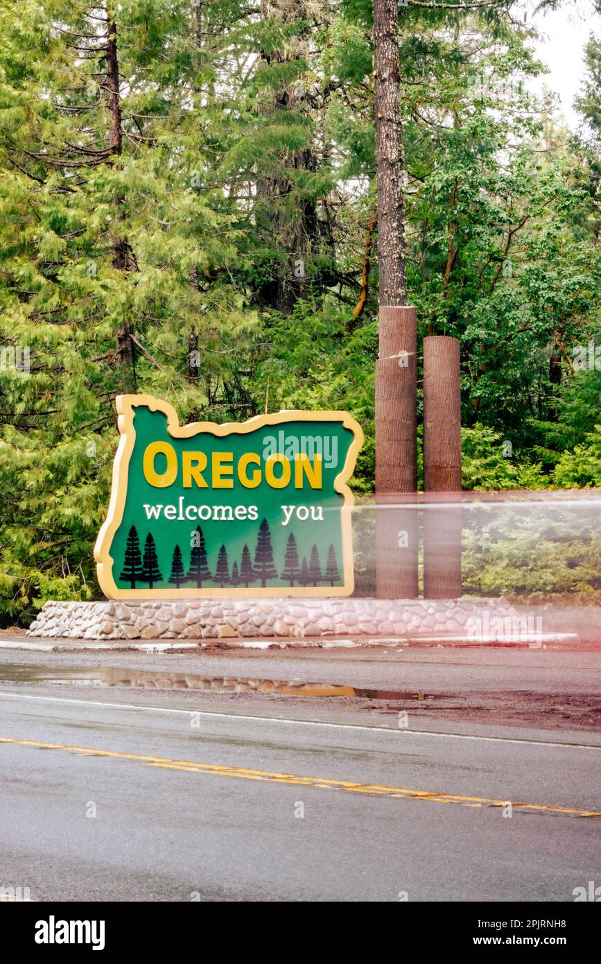 Long exposure image of Oregon welcomes you sign on US-199 as car zooms ...