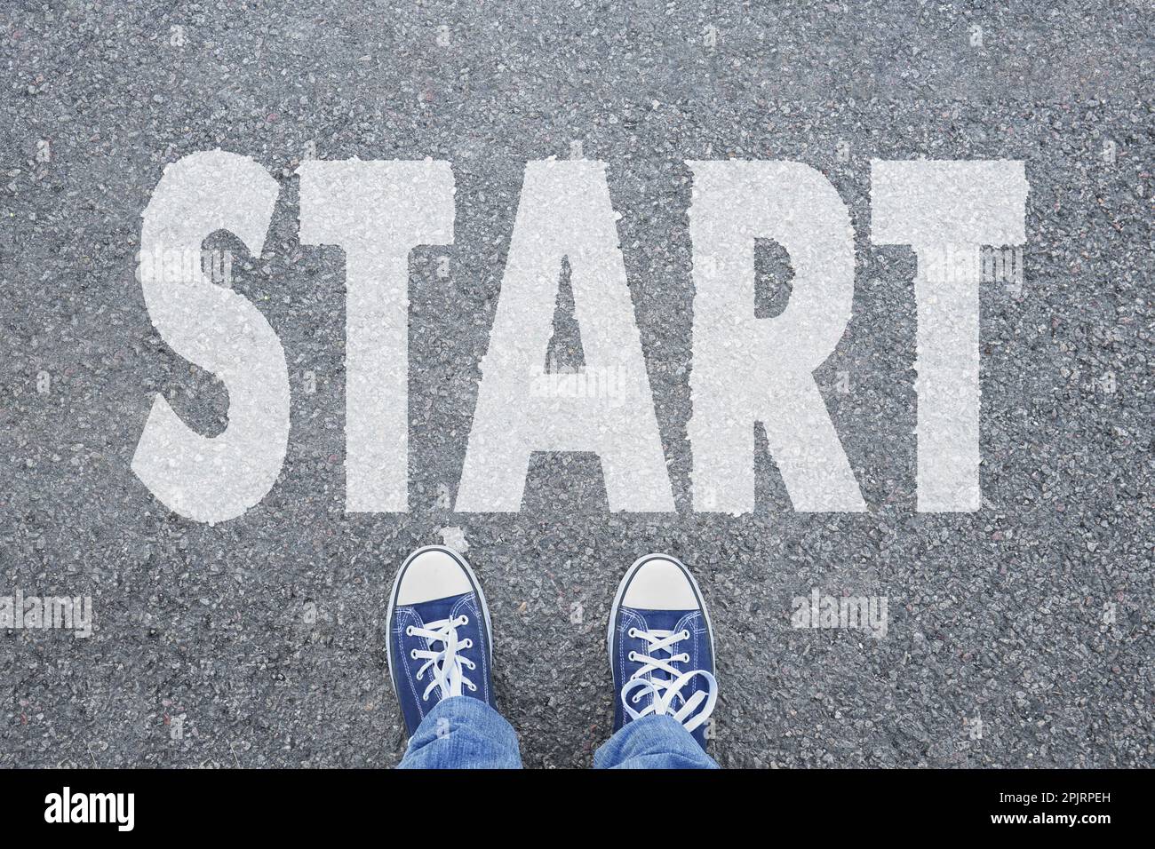 Man standing on road near word Start, top view Stock Photo - Alamy