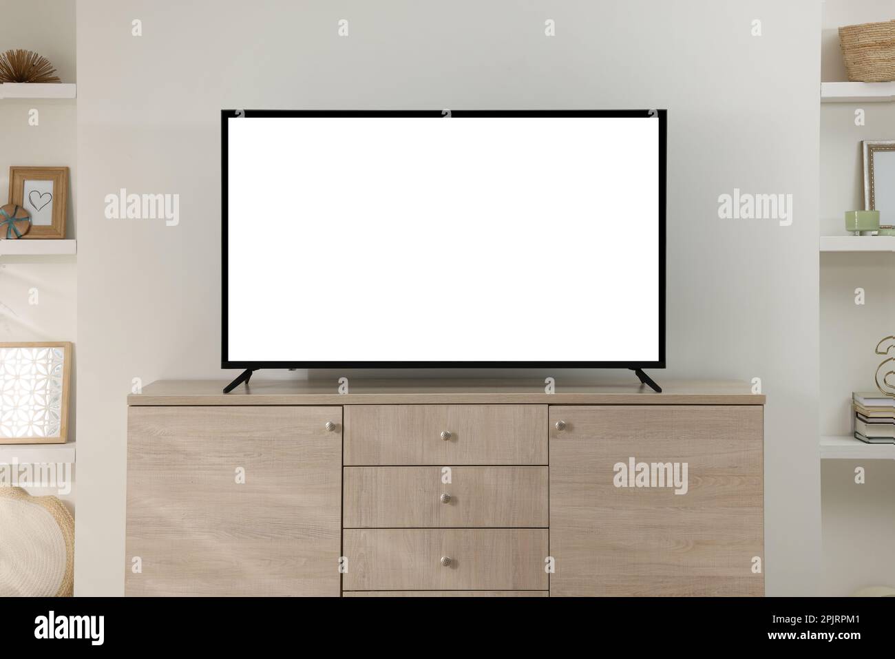 Modern TV set on wooden cabinet in room Stock Photo - Alamy