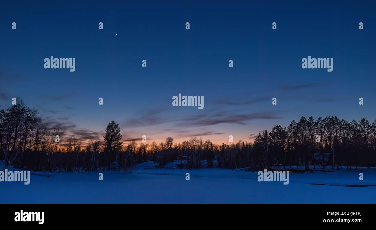 Crescent moon over Loretta Lake in northern Wisconsin Stock Photo - Alamy