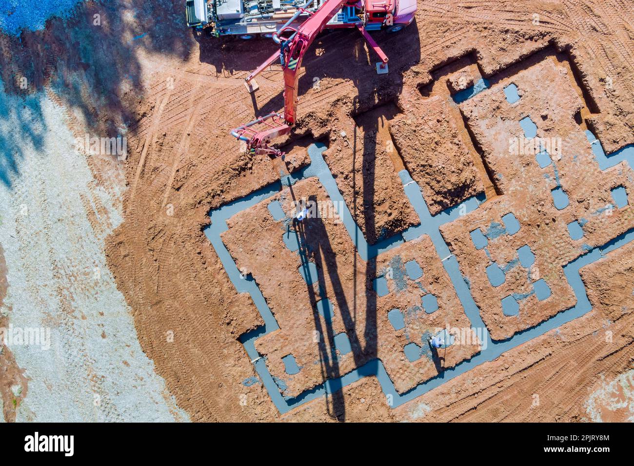 In course of construction house, concrete strip foundations are poured ...