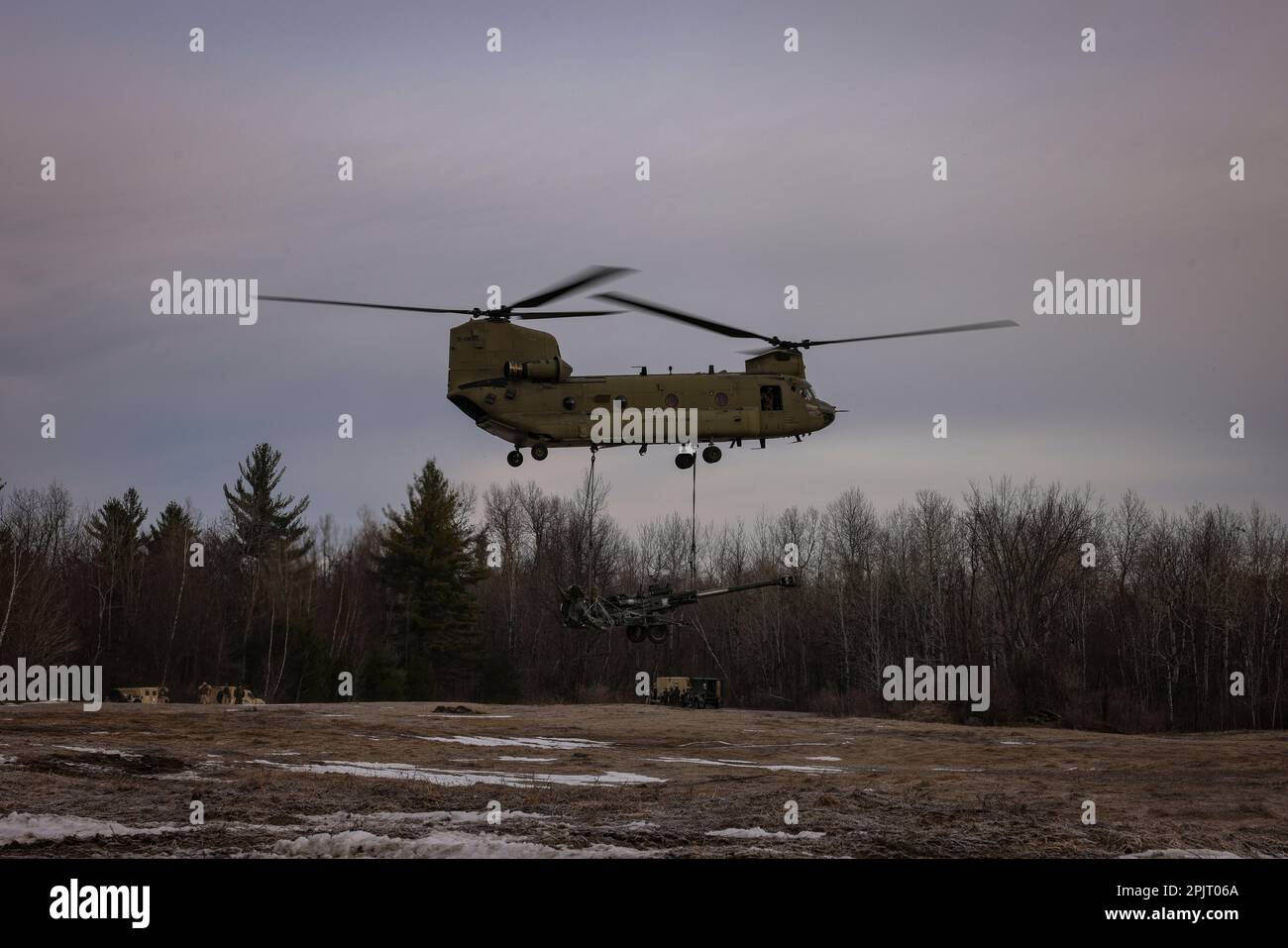 A U.S. Army CH-47 Chinook prepares to drop a M777 towed 155 mm howitzer ...