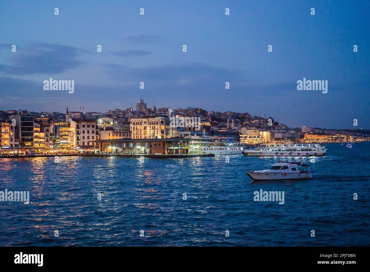 Istanbul at sunset, Turkey. Tourist boat sails on Golden Horn in summer ...