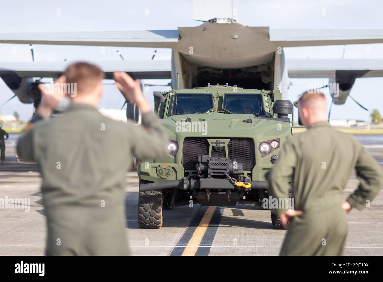 U.S. Marines with Marine Aerial Refueler Transport Squadron 153 guide a ...