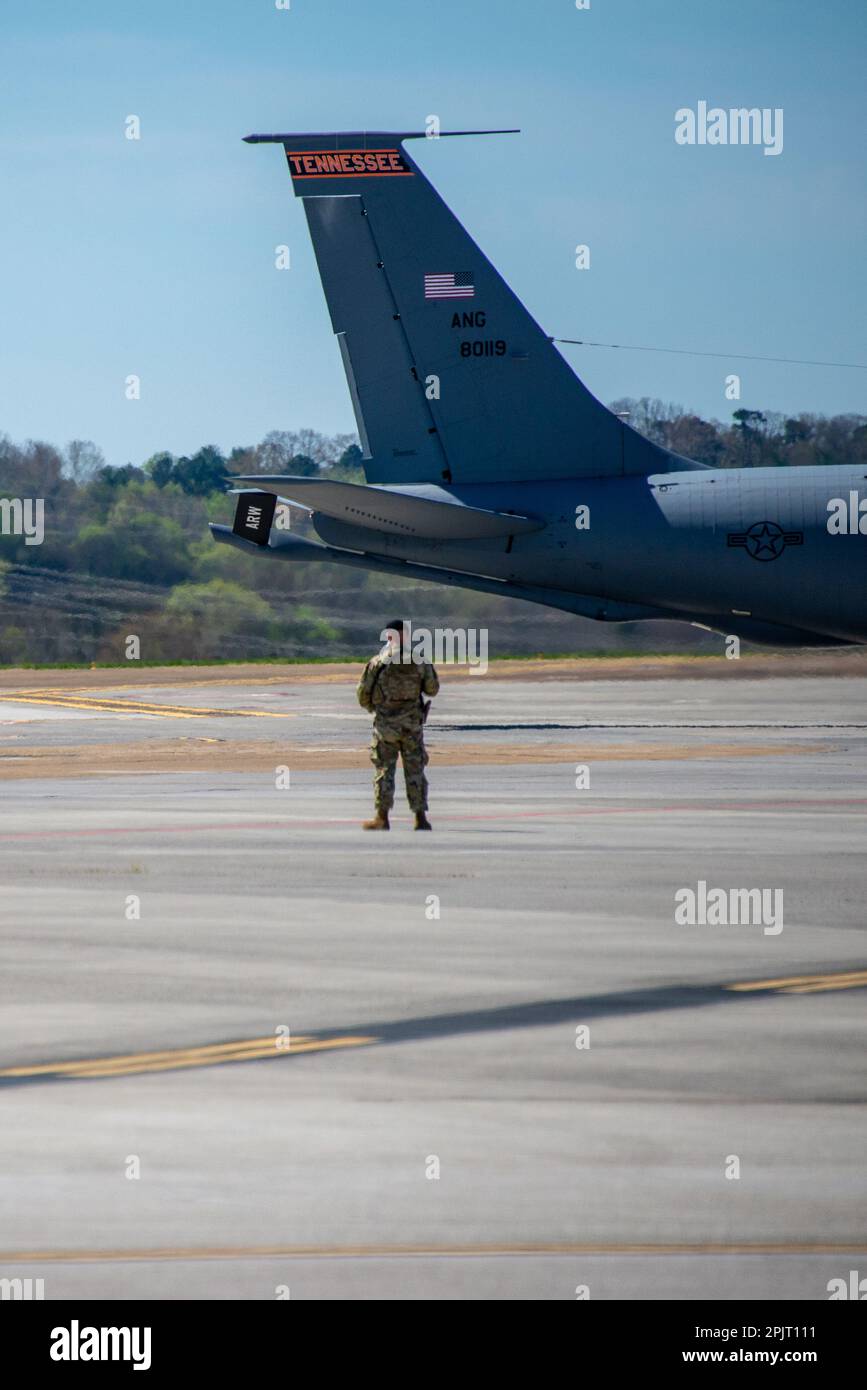 A 134th Security Forces member stands guard as a KC-135 passes from the ...