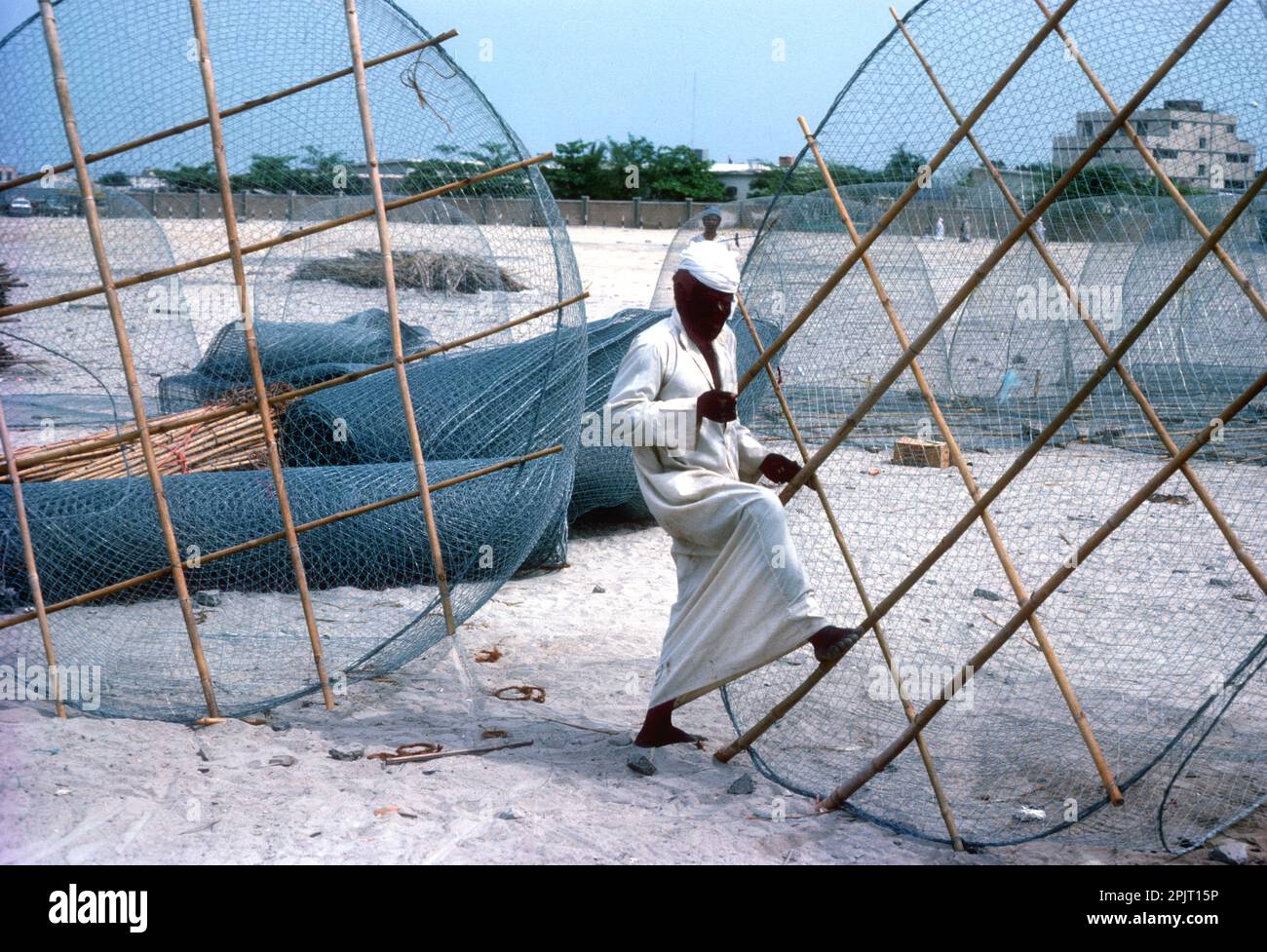 Arab of African heritage weaving wire fish-traps or gandours, Dubai ...