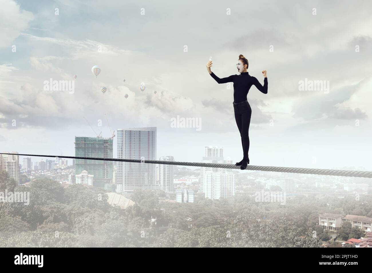 Female mime with white face on the rope Stock Photo - Alamy