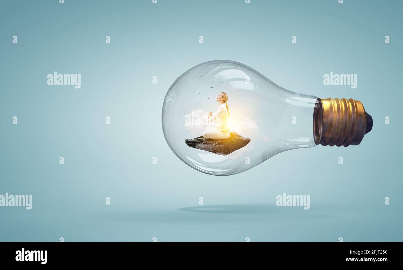 Business woman doing yoga in lotus pose inside light bulb Stock Photo ...