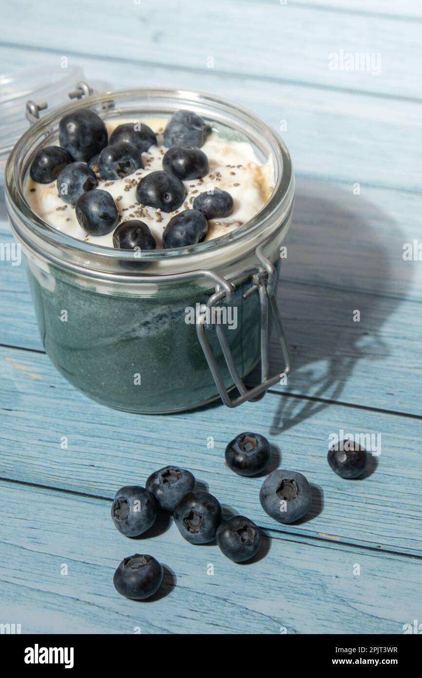 Glass jar with natural organic homemade yogurt and blueberries ...