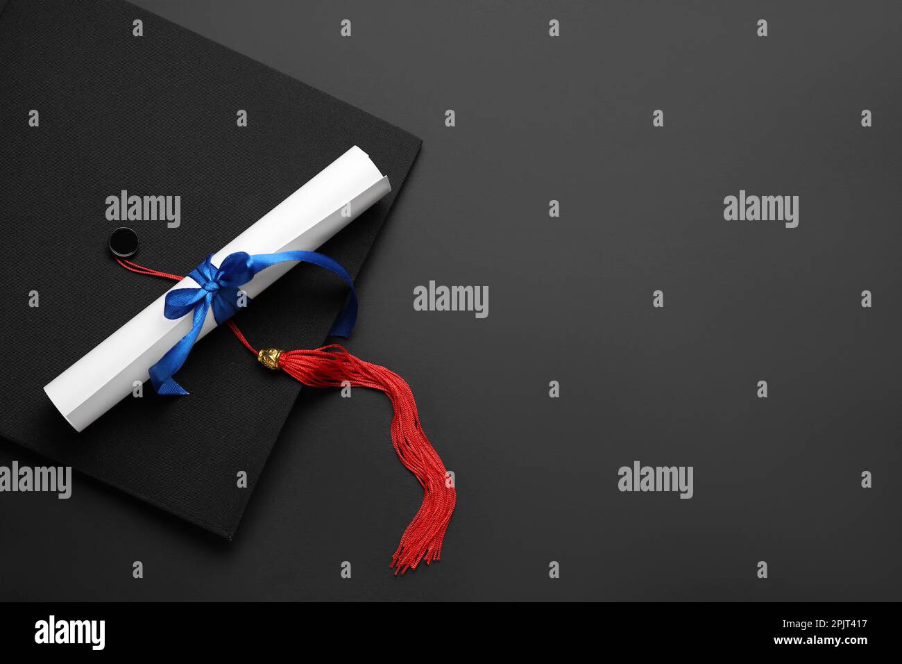 Diploma with blue ribbon and graduation hat on black background Stock ...
