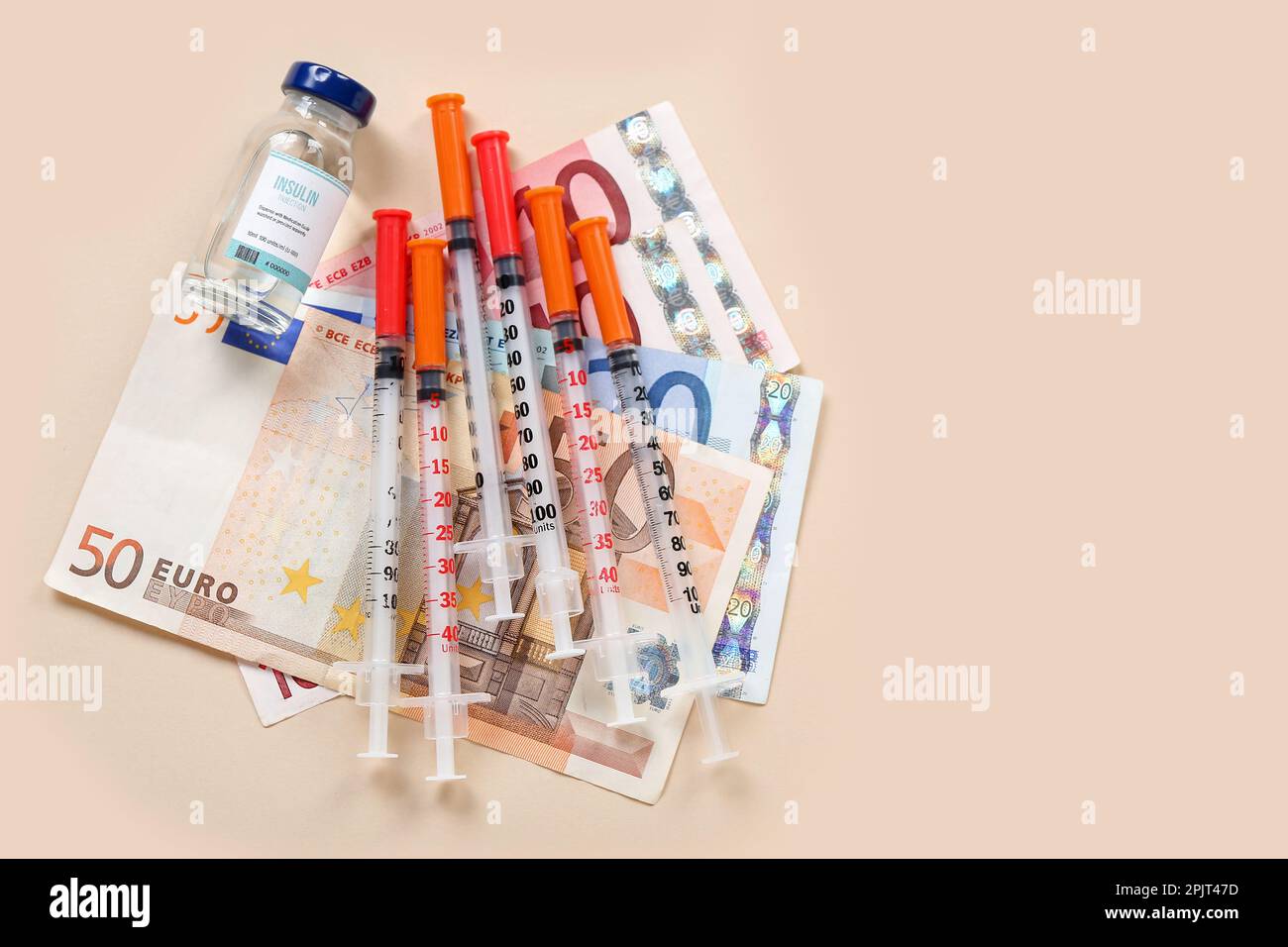 Insulin with syringes and money on beige background. Expensive medicine ...