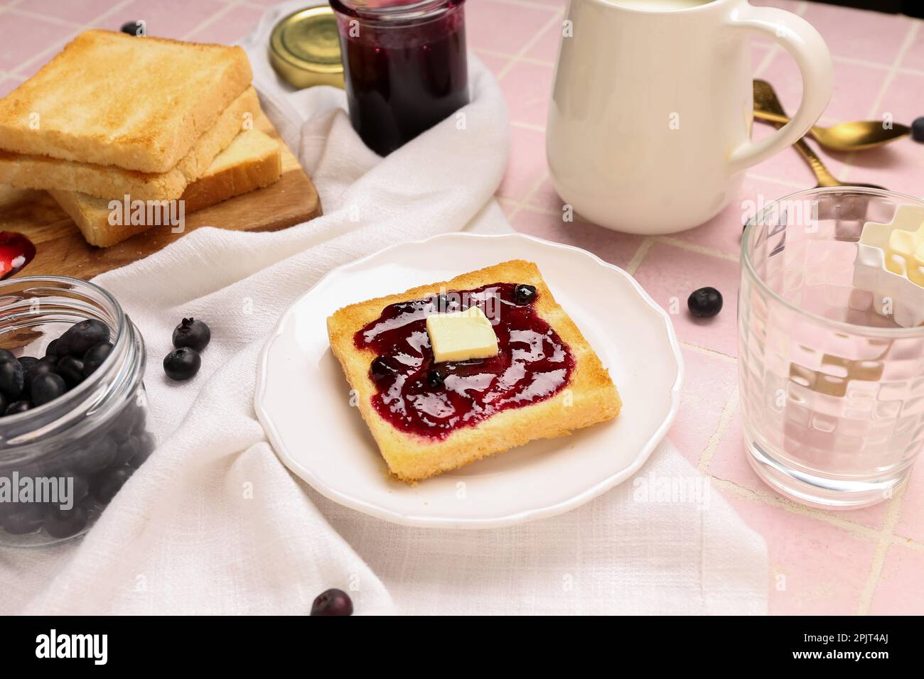 Plate of tasty toast with blueberry jam on pink tile background Stock ...