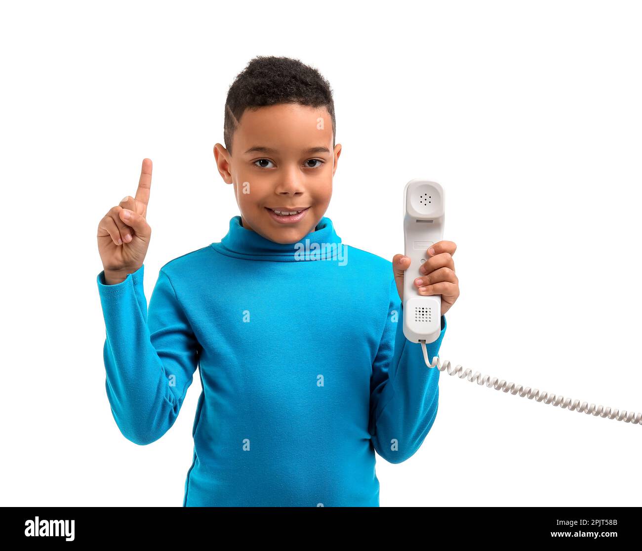 Little African-American boy with telephone receiver and raised index ...