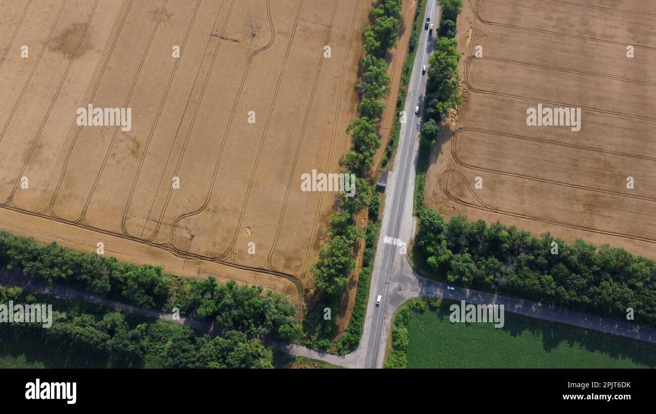 Automobile asphalt road with cars driving between agricultural fields ...