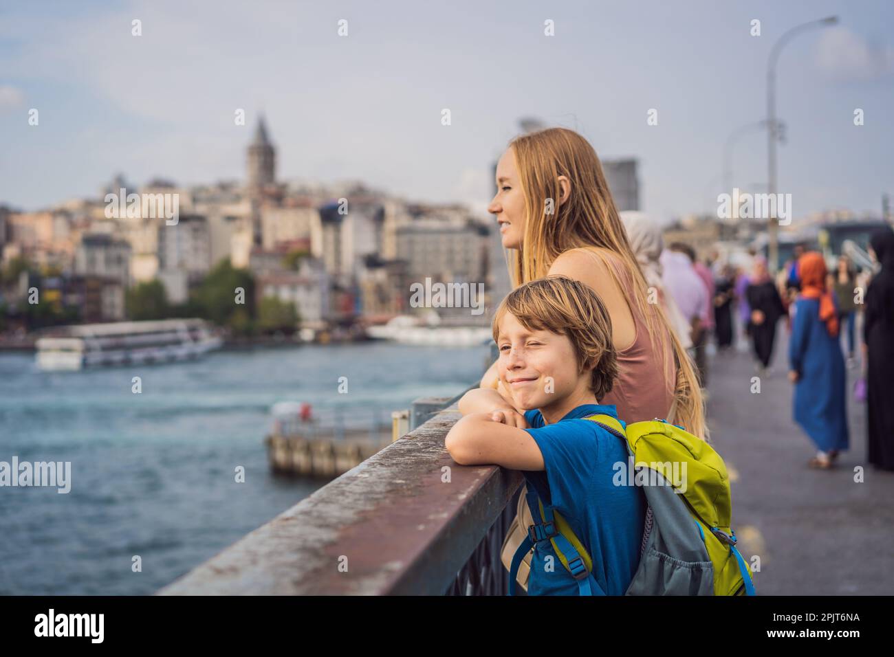 Portrait of beautiful mother and son tourists with view of Galata tower ...